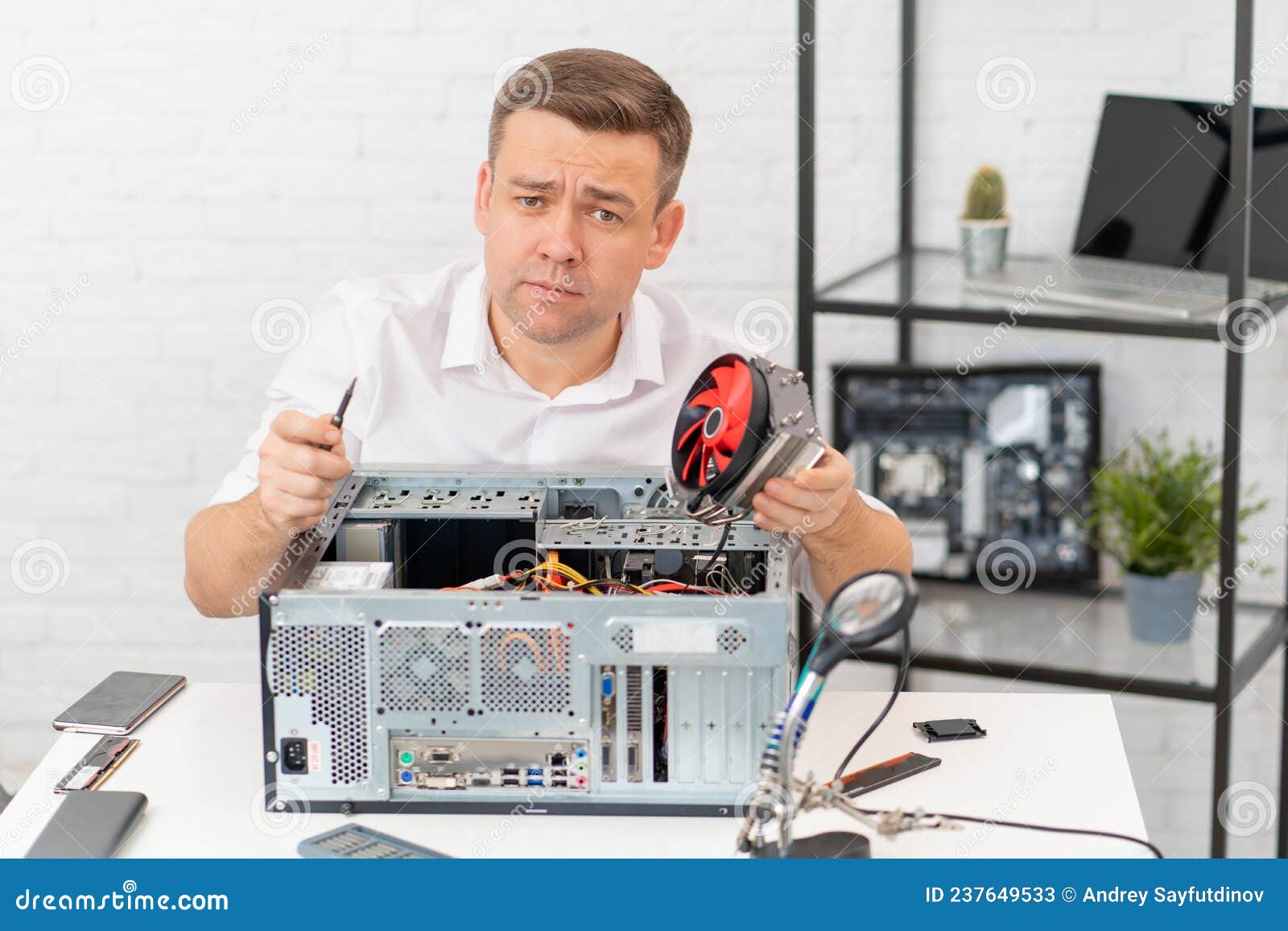 Computer Breakdown. Workshop. Serious Man Installs a Cooler in in a ...