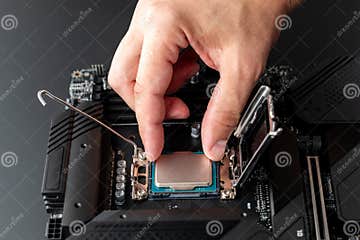 Computer CPU Installation. Hand of Master Installs Processor Chip on ...