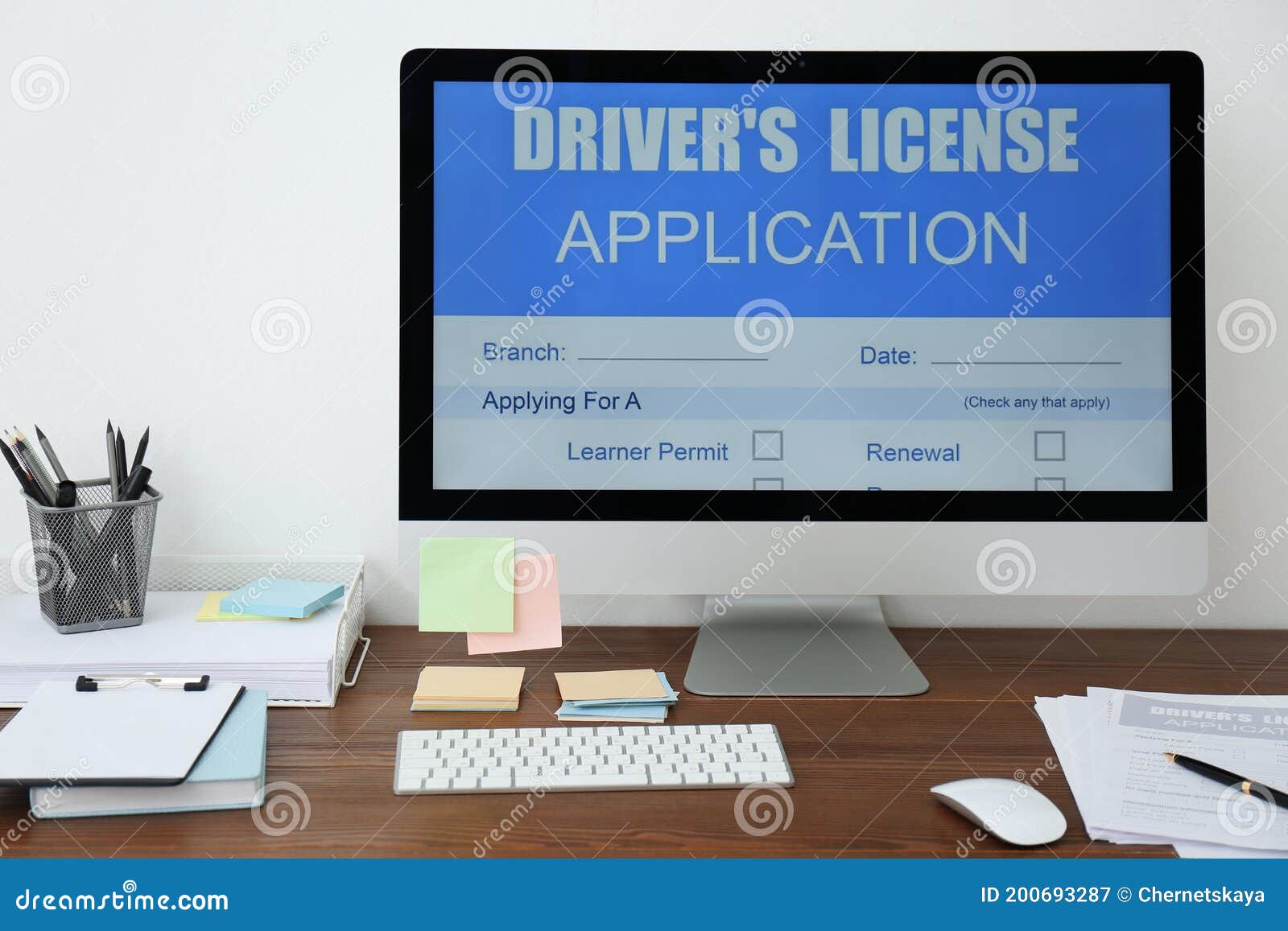 Computer with Driver`s License Application Form on Table in Office ...