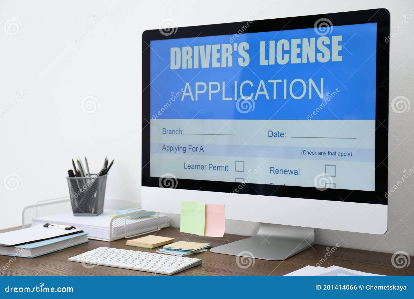 Computer with Driver`s License Application Form on Table in Office ...