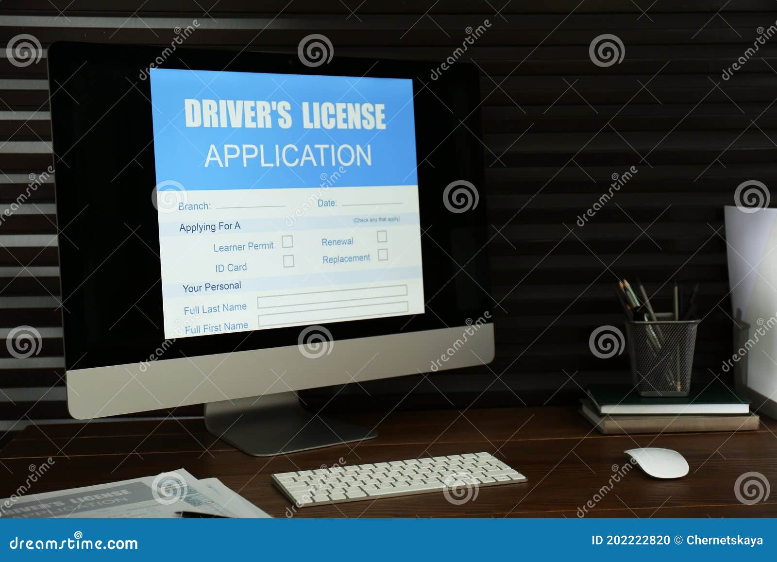 Computer with Driver`s License Application Form on Table in Office ...