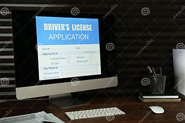 Computer with Driver`s License Application Form on Table in Office ...
