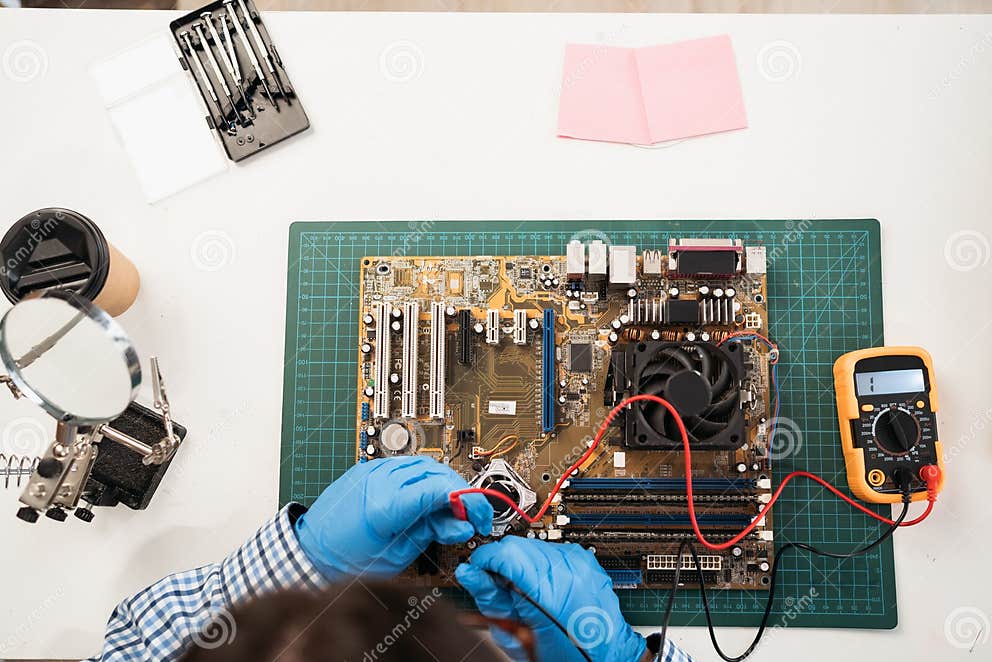 Computer Engineer Working on an Old Motherboard, Testing it with ...