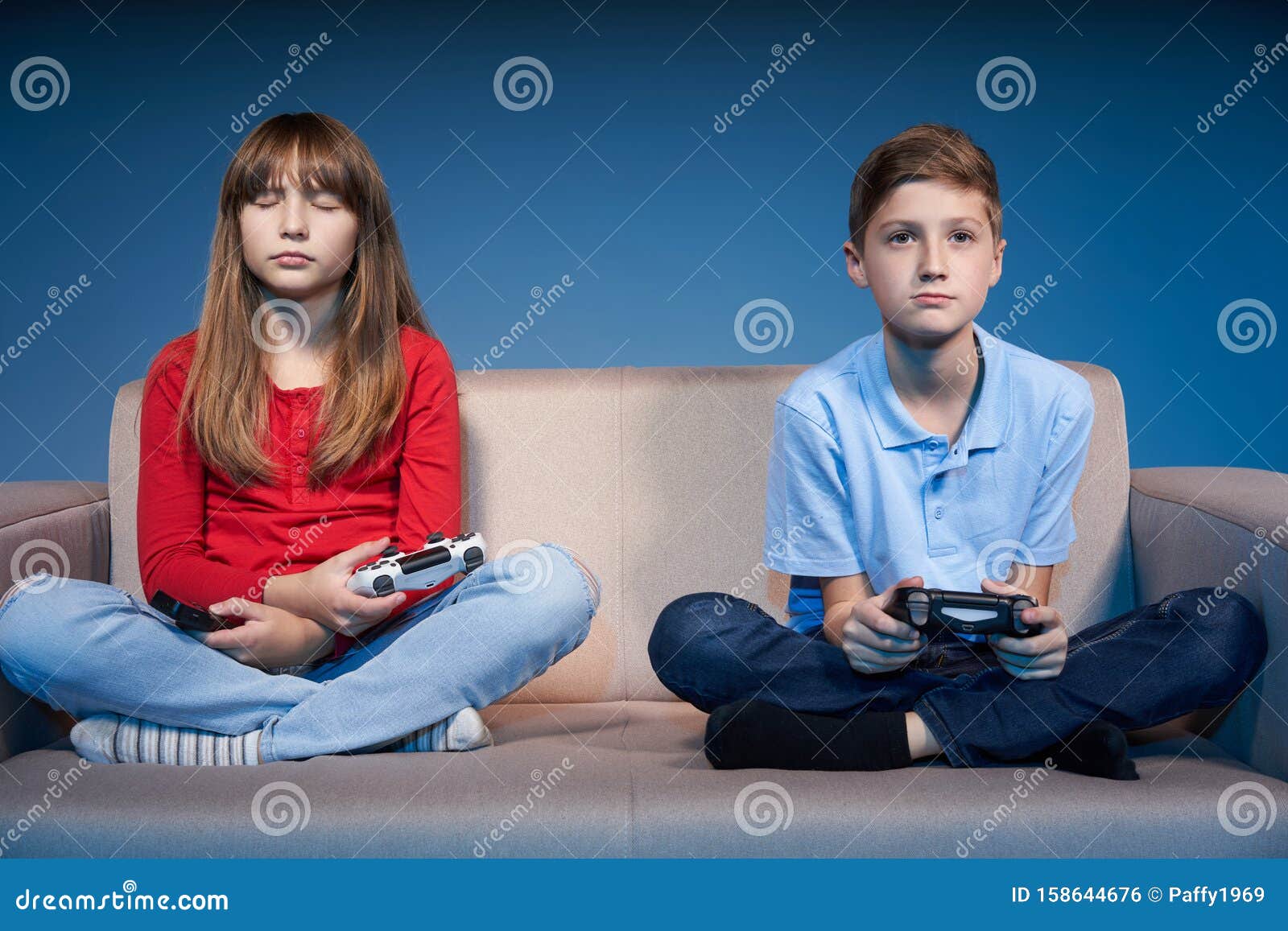 Children Sitting on Sofa Playing Video Game with Joysticks Stock Photo ...