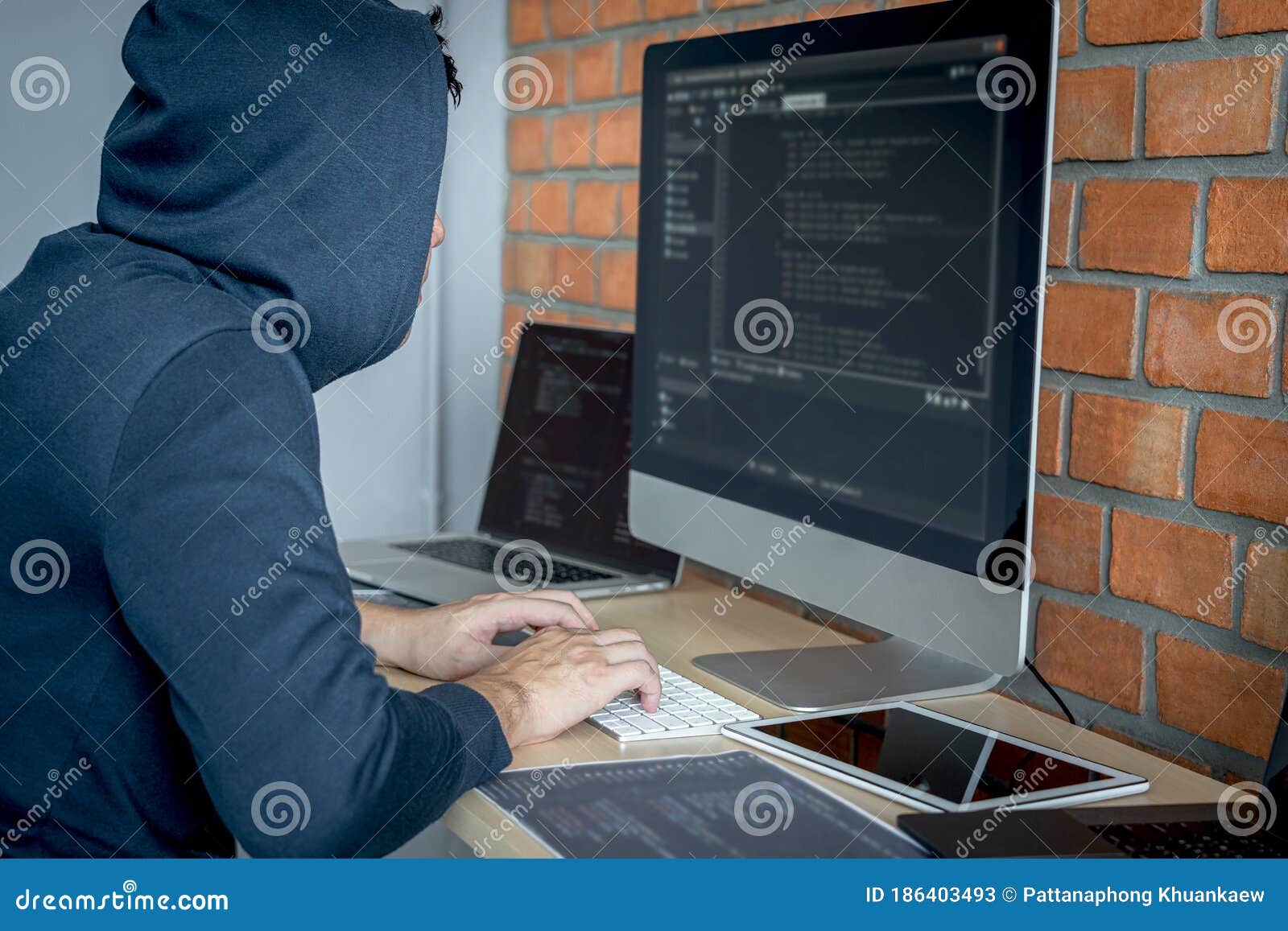 Computer Hacker or Cyber Attack Concept, Dangerous Hooded Hacker Using Multiple Computers Typing ...