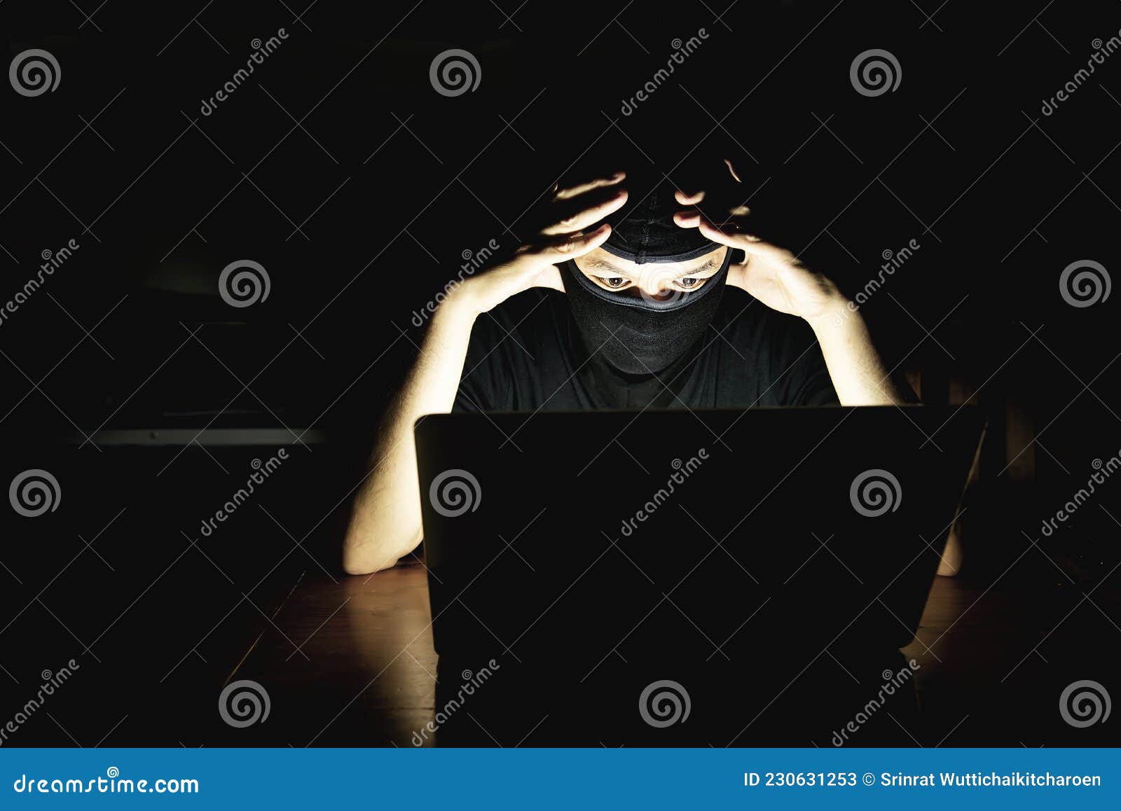 Computer Hacker Doing His Job with Laptop Computer in the Dark Room ...