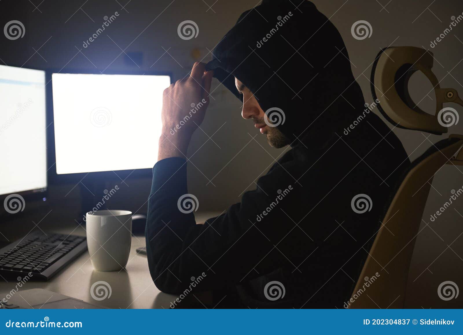 Computer Hacker. Young Man In Black Hoodie Using Multiple Computers For ...