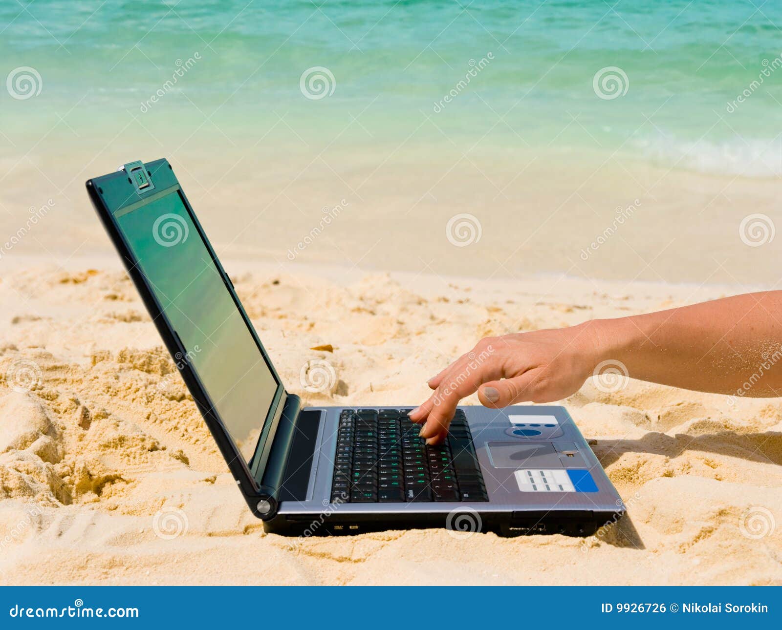 Computer and hand on beach stock photo. Image of laptop - 9926726