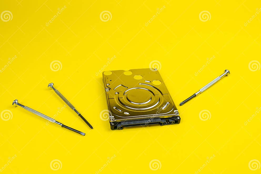 Computer Hard Disk Drive Isolated on Yellow with a Screwdrivers Stock ...