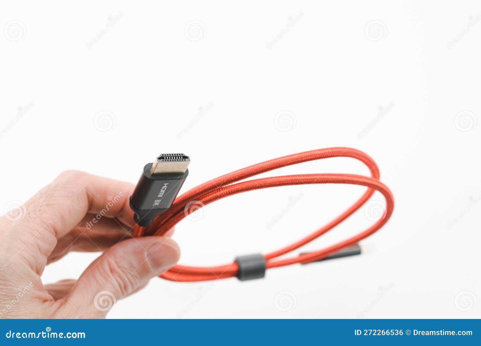 Image with Hand Holding Compuer Cables and Wires on a White Surface ...