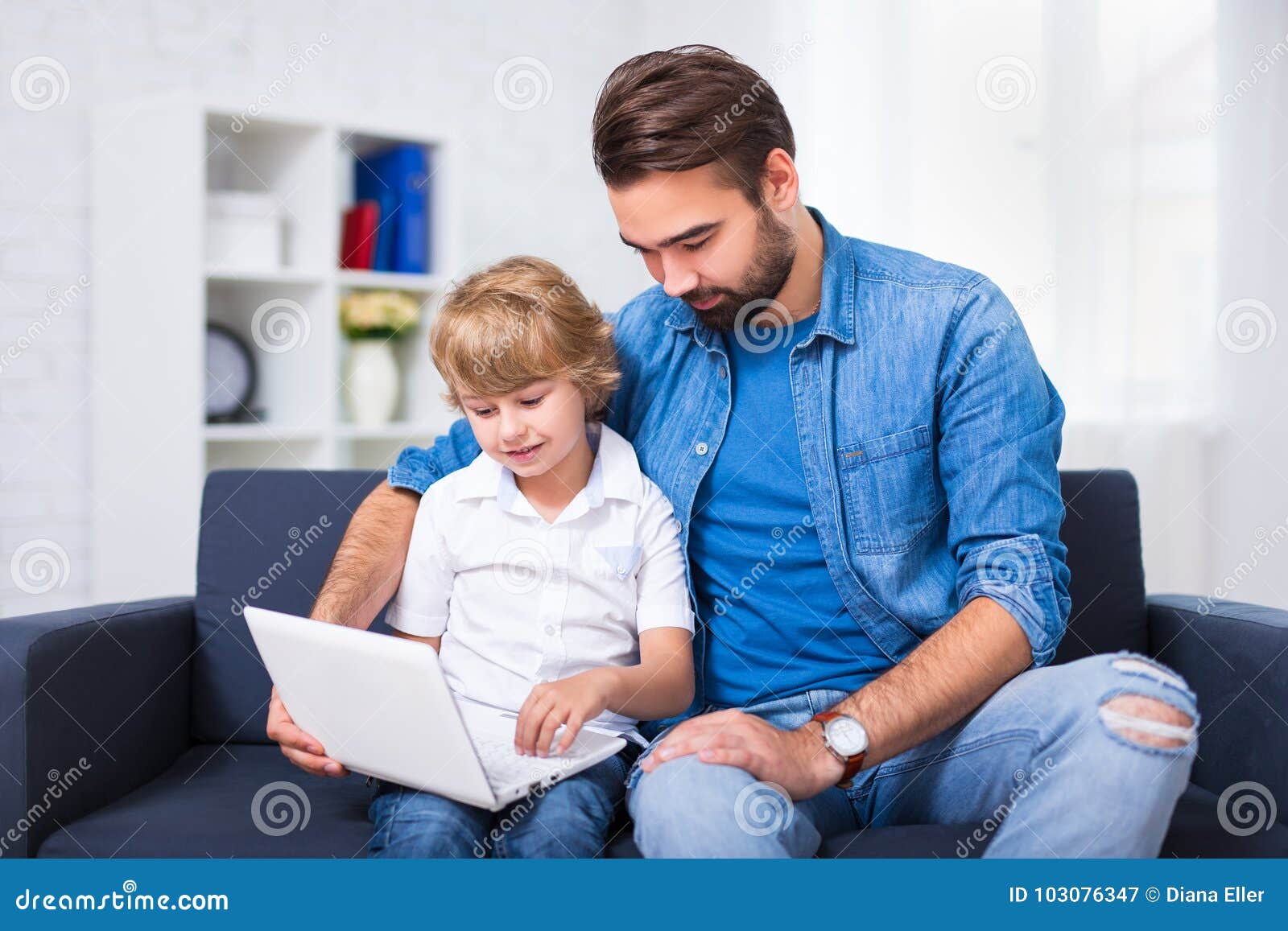 Computer and Internet Concept - Young Father and Son Sitting on Stock ...
