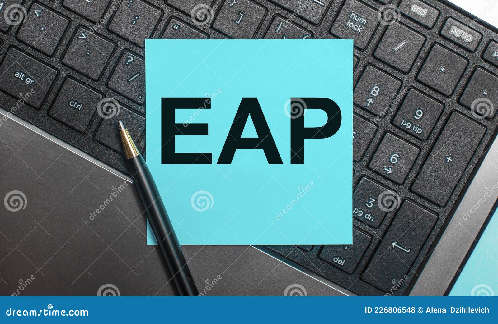 The Computer Keyboard Has a Pen and a Blue Sticker with the Text EAP ...