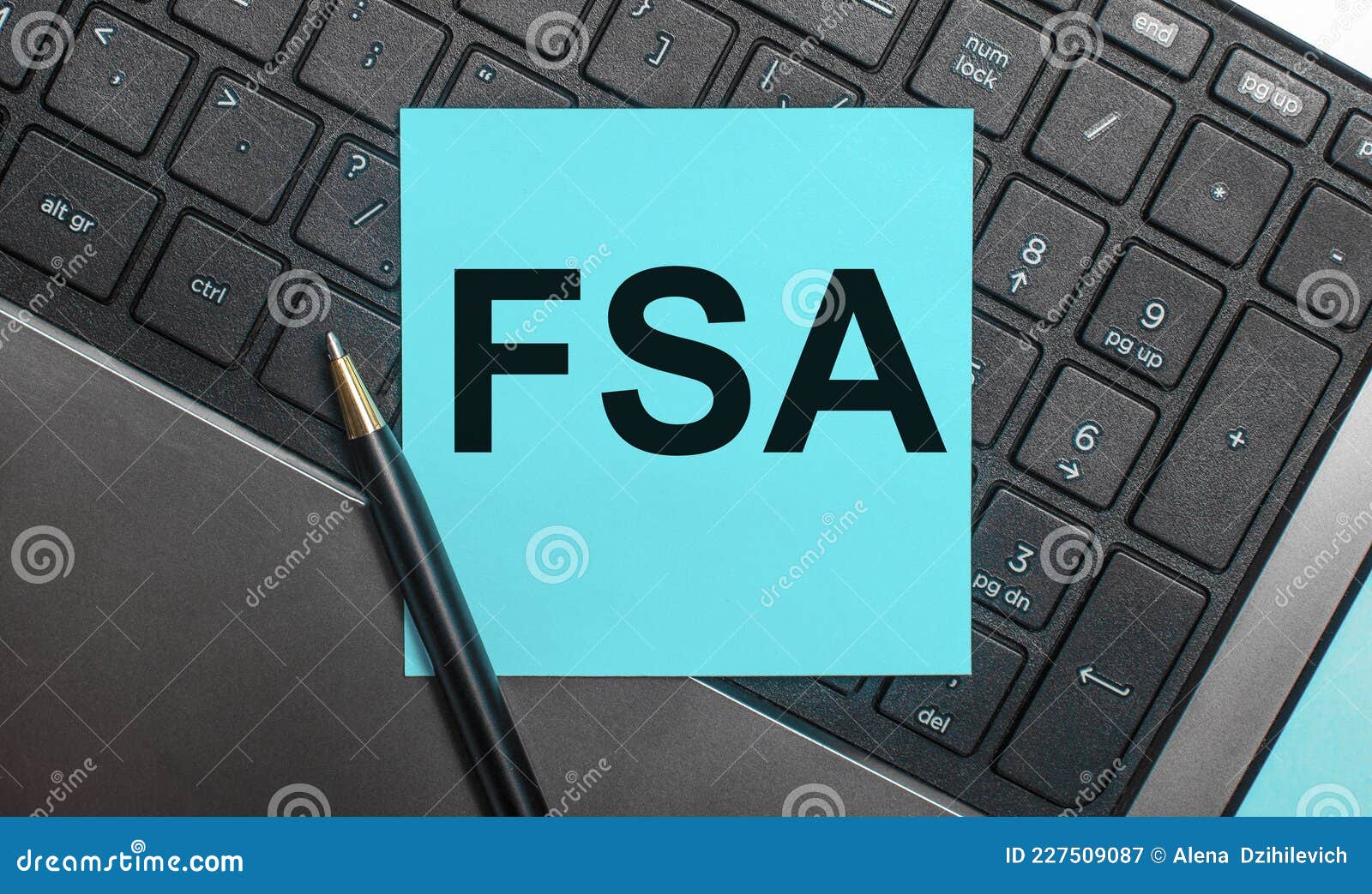 The Computer Keyboard Has a Pen and a Blue Sticker with the Text FSA ...