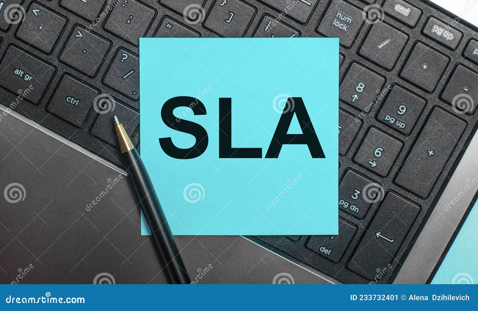 The Computer Keyboard Has a Pen and a Blue Sticker with the Text SLA ...