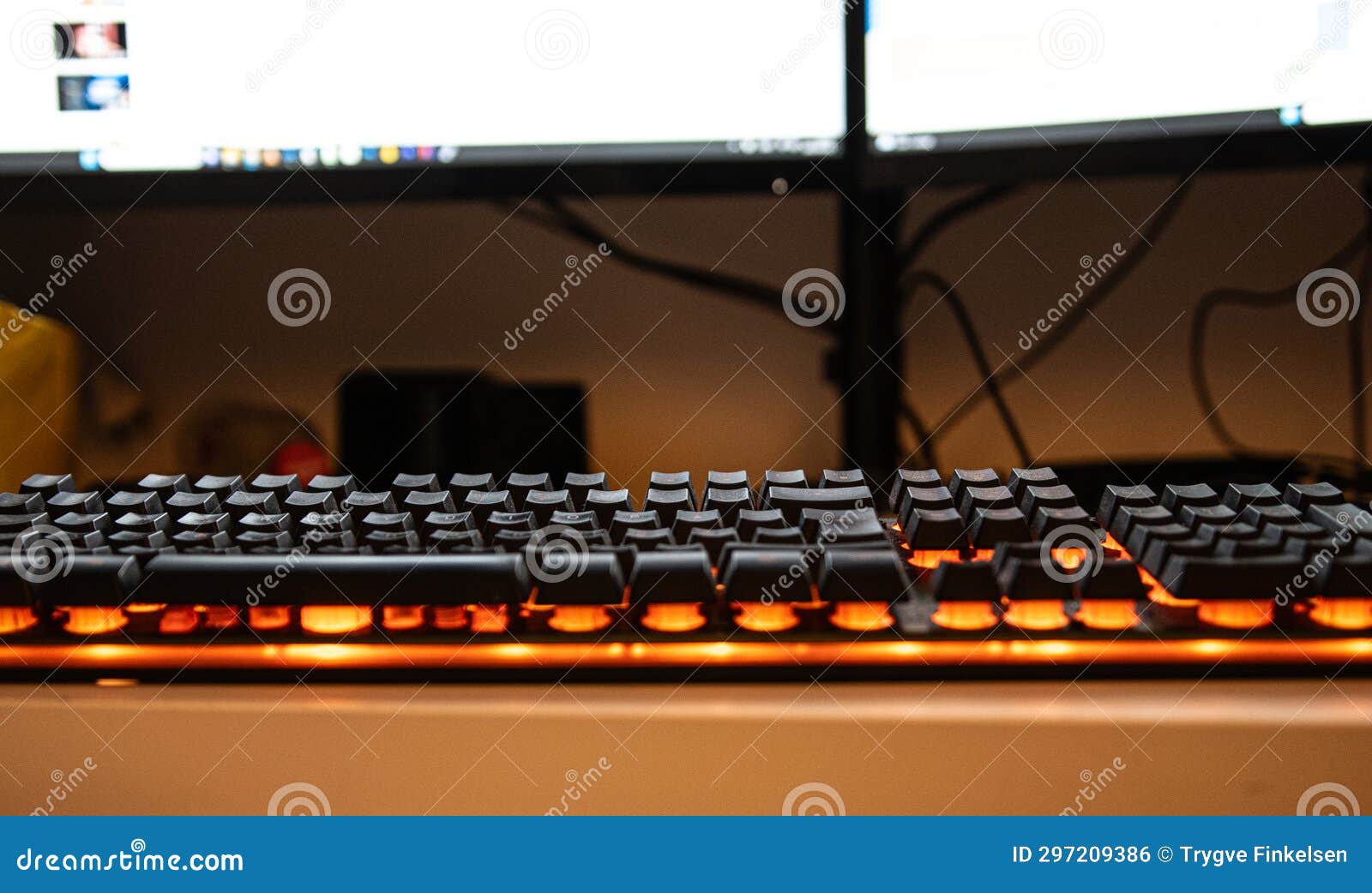 Computer Keyboard with Orange Lights in Front of Computewr Screens ...