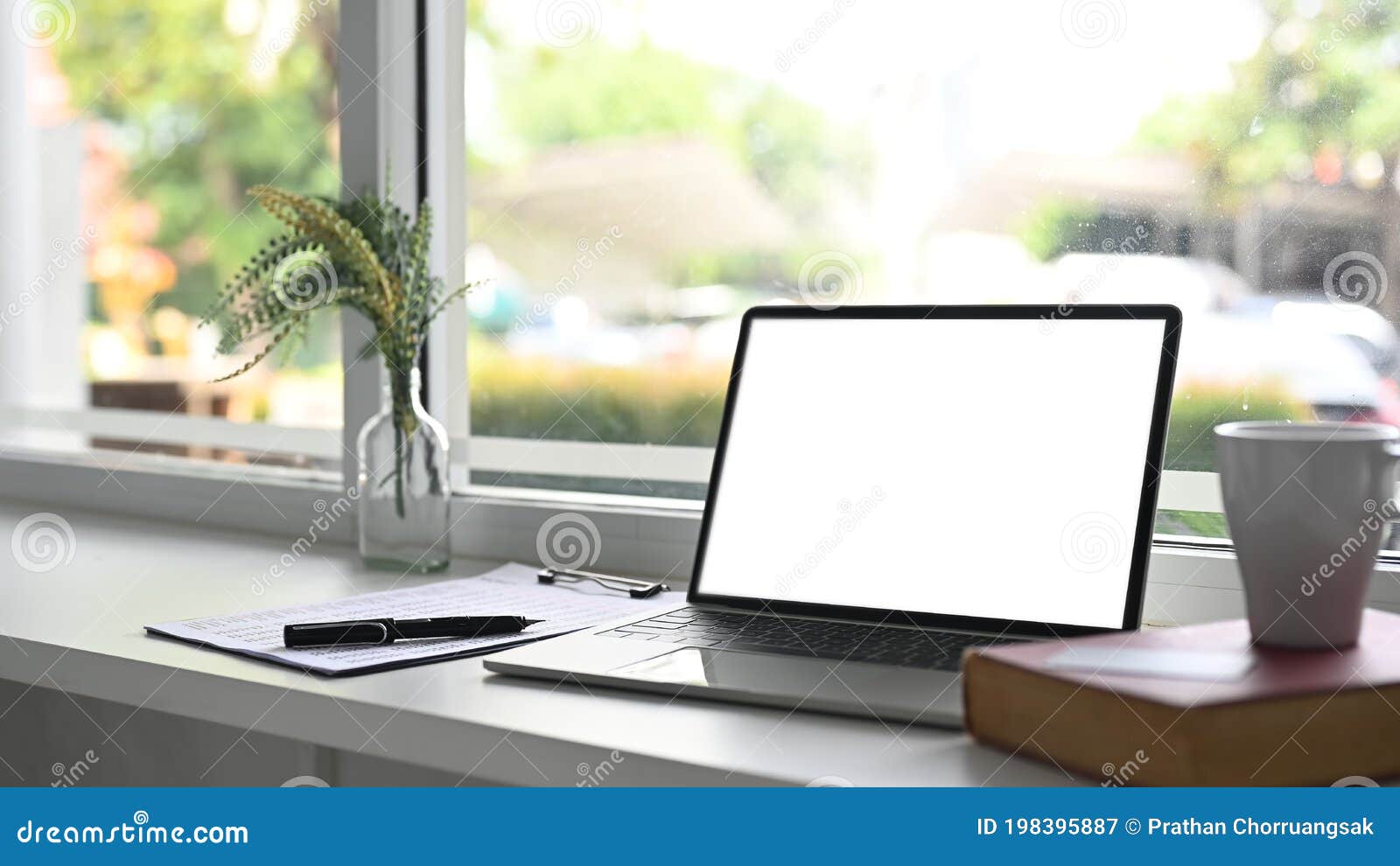 A Computer Laptop with a White Blank Screen is Putting on a Windowsill ...