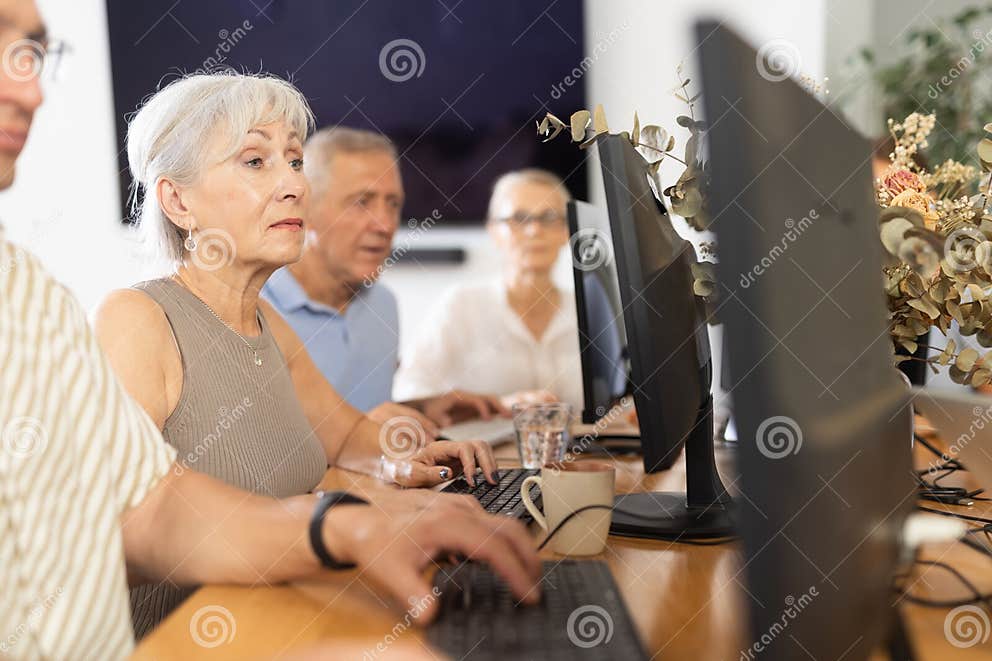 Computer Lessons for Elderly People in Nursing Home. Group of Seniors ...