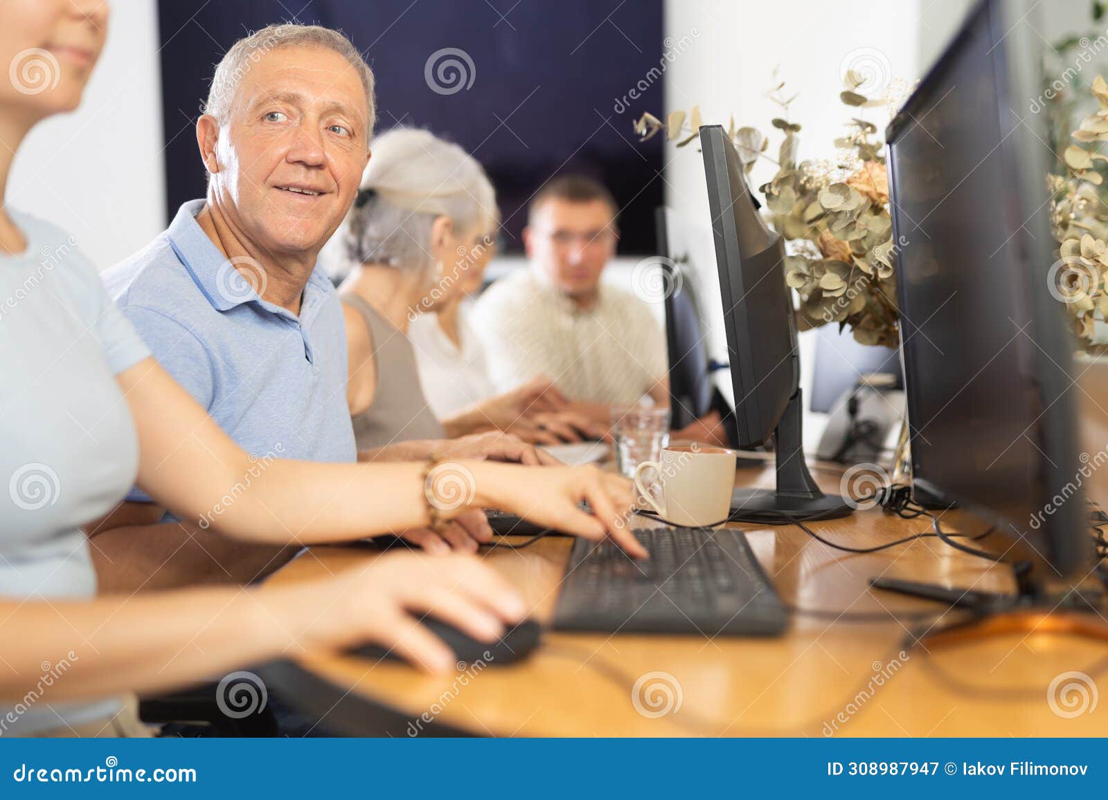 Computer Lessons For Elderly People In Nursing Home Group Of Seniors