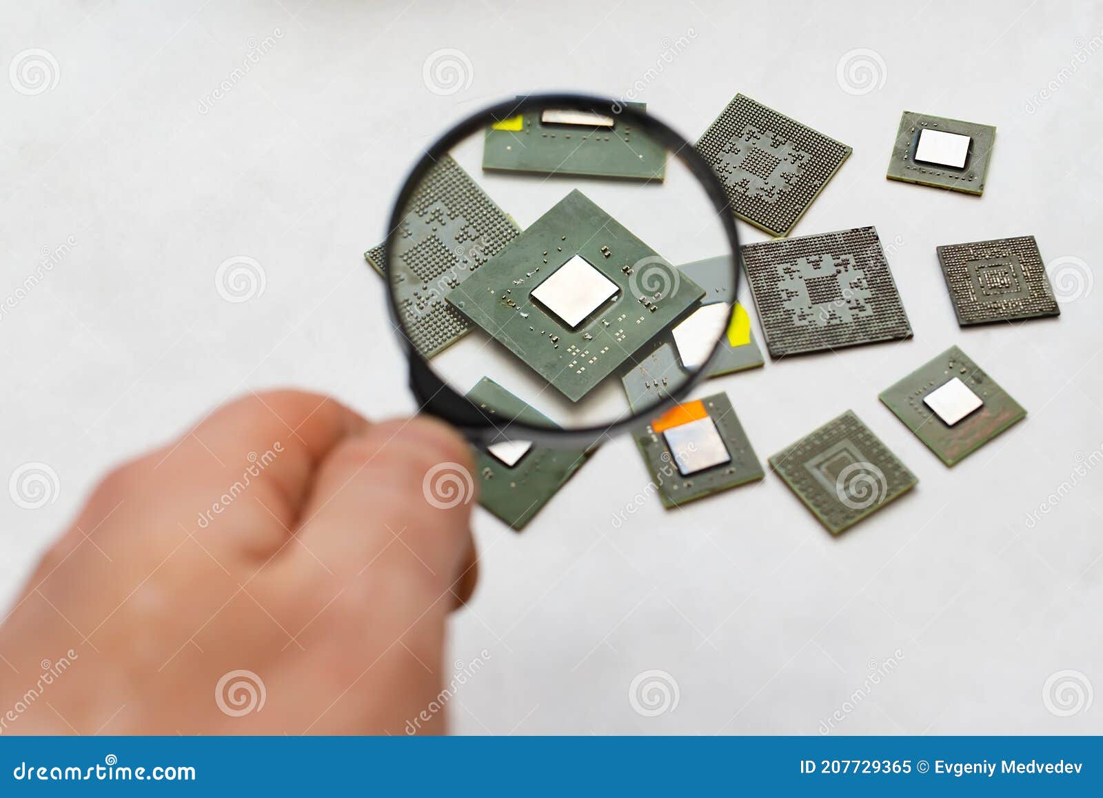 Computer Microprocessor that a Person Views through a Magnifying Glass ...