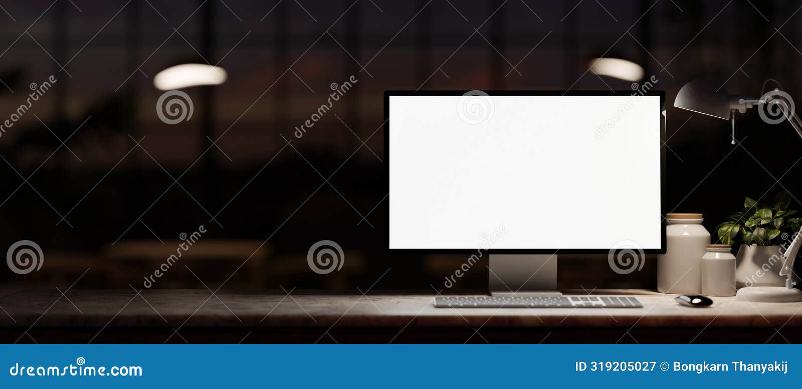 A Computer Mockup, Decor, and a Dim Light from a Lamp on a Table in a ...
