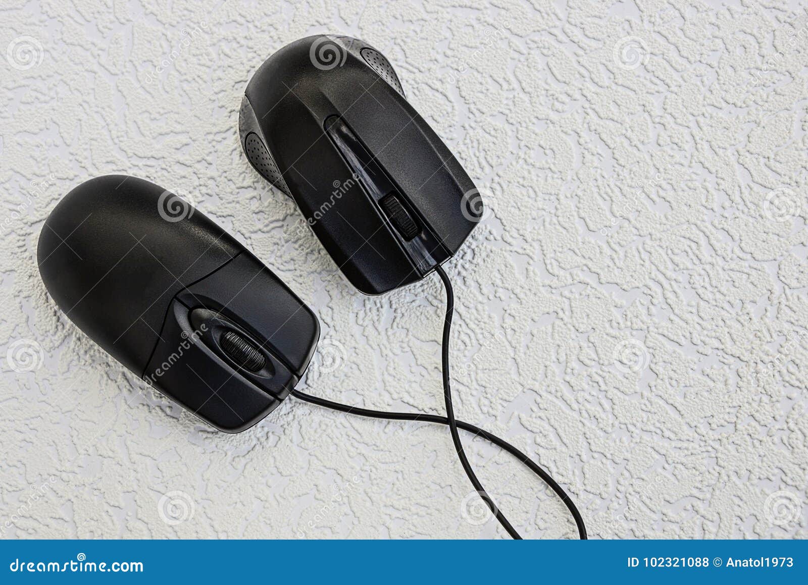 Two Black Computer Mice with a Wire on a Gray Surface Stock Photo ...