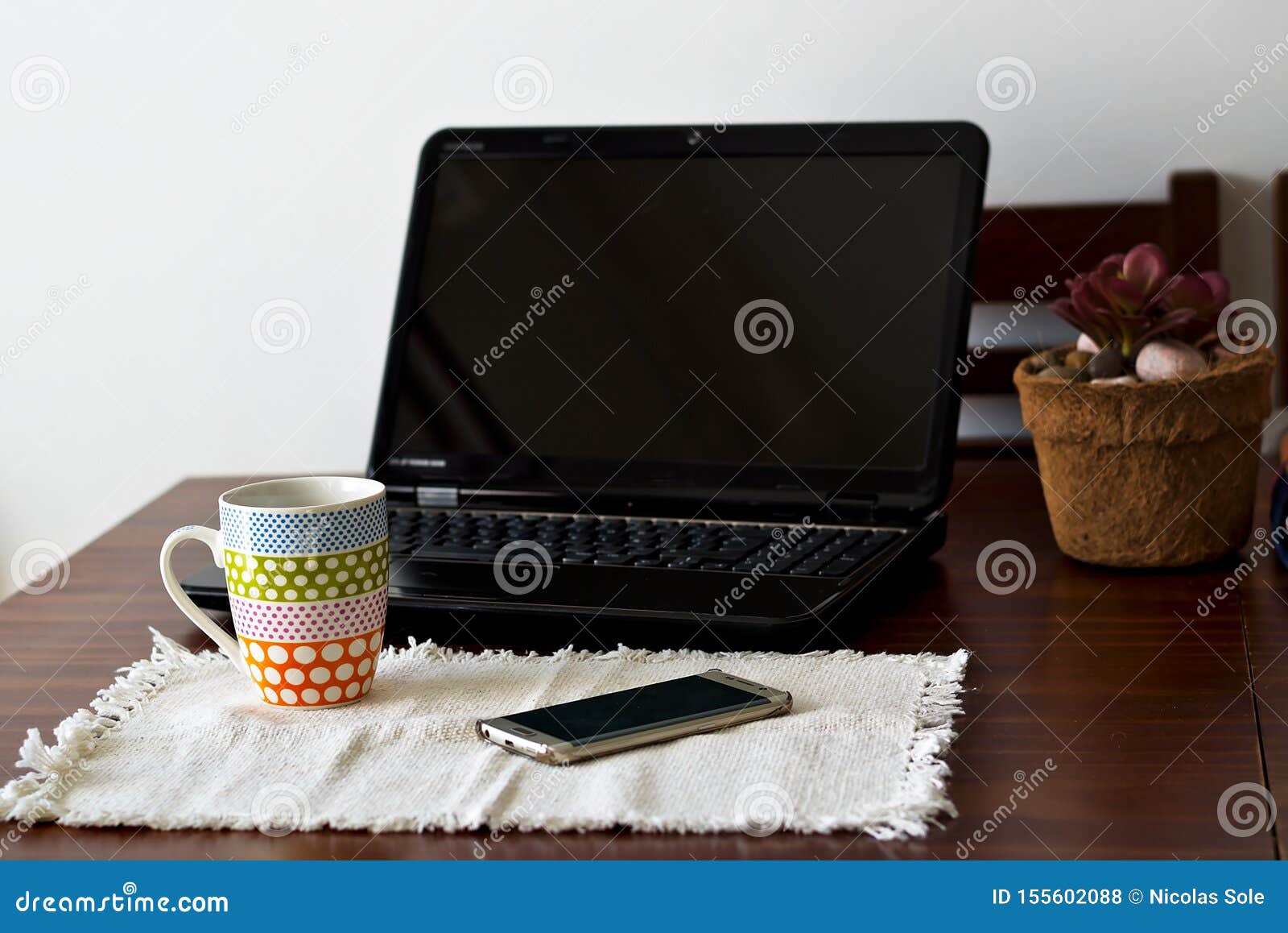 Computer Next To a Cup of Coffee, a Plant and a Cell Phone Stock Photo ...
