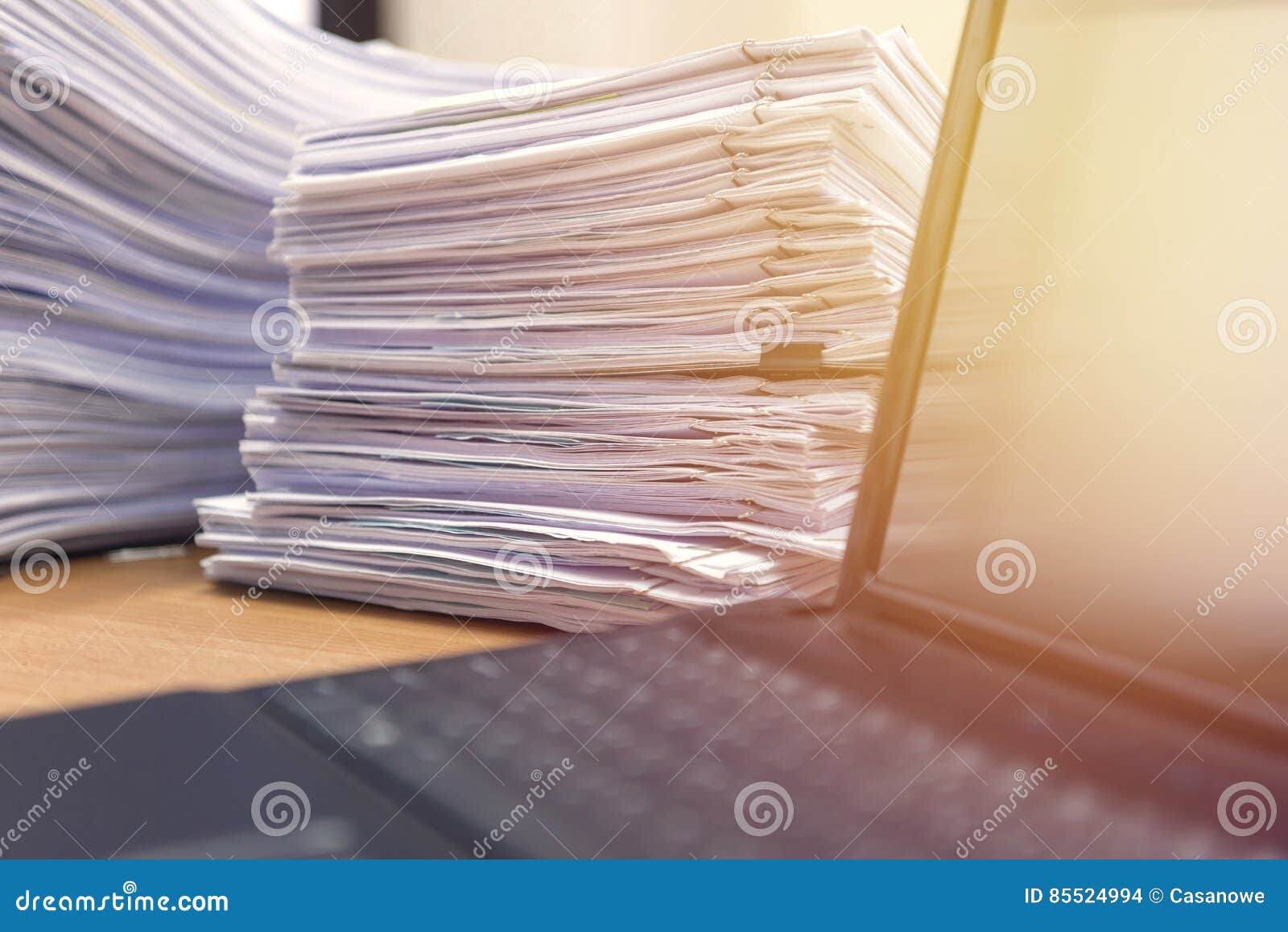 Computer Notebook and Documents on Desk Stack Up High Waiting To Stock ...