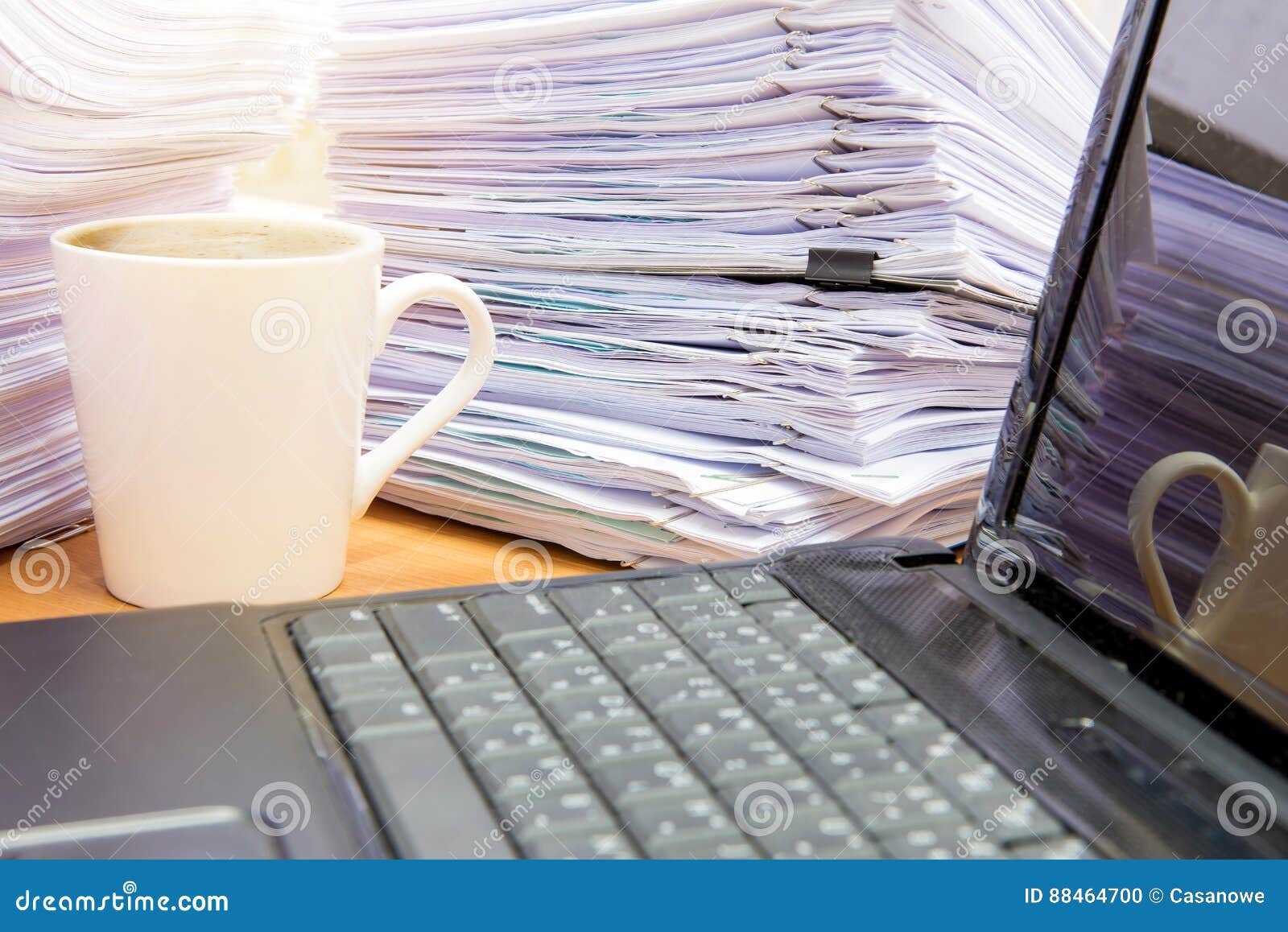 Computer Notebook and Documents on Desk Stack Up High Waiting To Stock ...