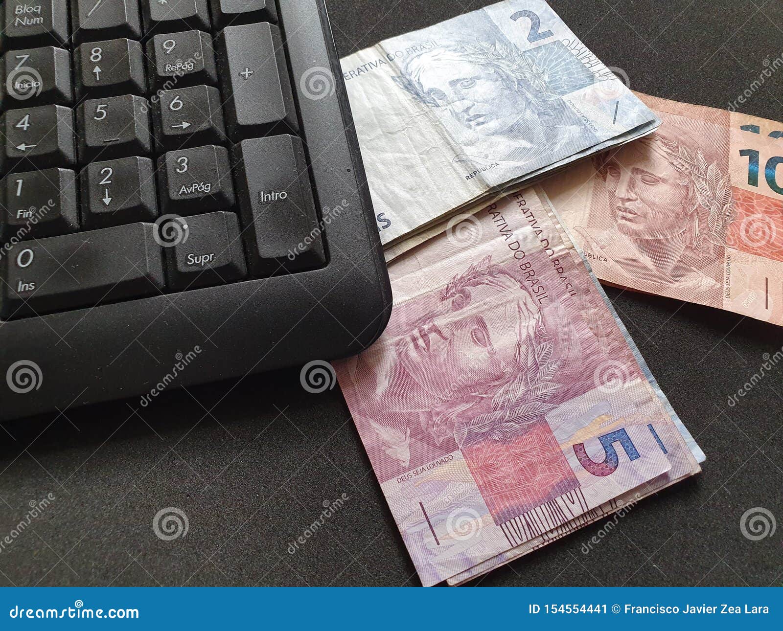 Computer Numeric Keypad and Brazilian Money on the Black Table Stock ...