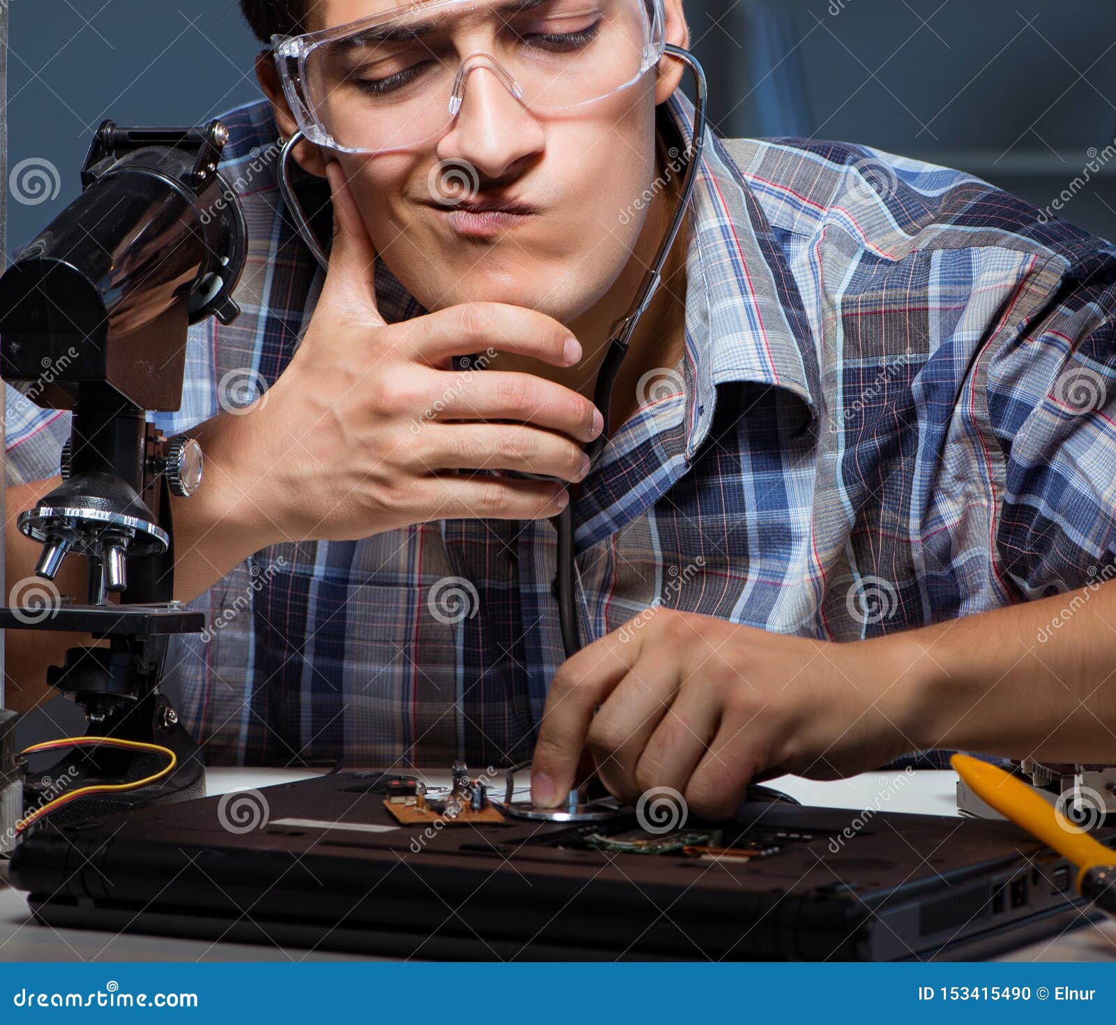 Computer Repair Concept with Man Inspecting with Stethoscope Stock ...