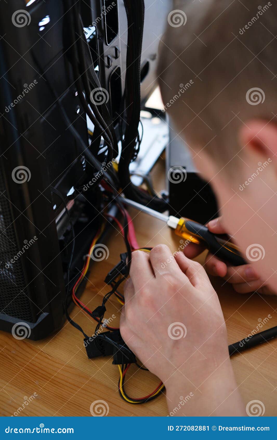 A Man Repairs a Cable in a System Unit and Connects Electrical Wires ...