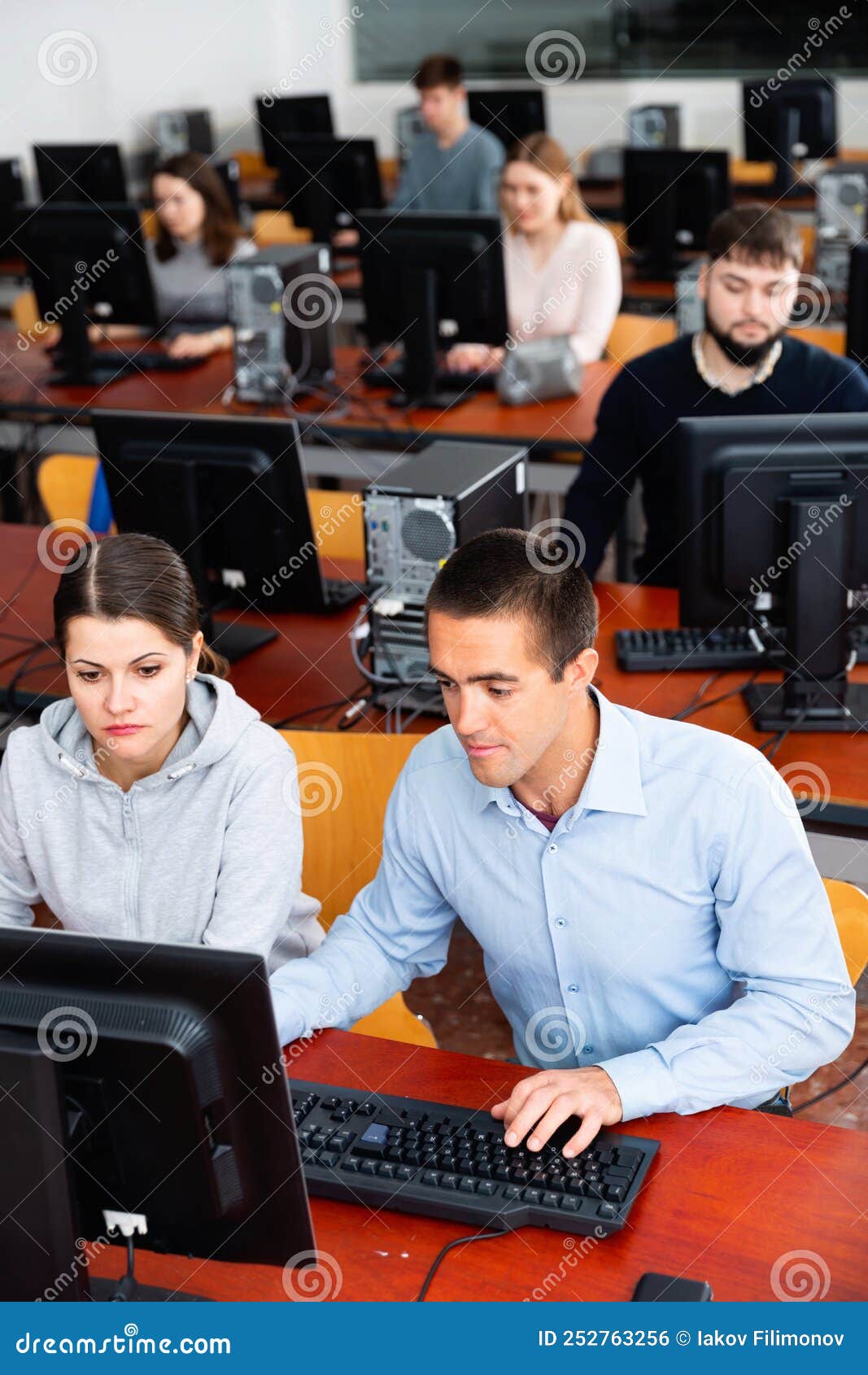 Computer Science Teacher Supervises The Execution Of A Programming Task In A Computer Class
