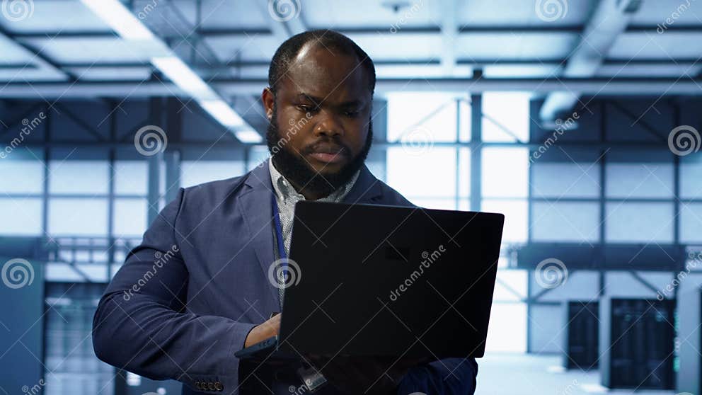 Computer Scientist in Data Center Using Diagnostic Tools on Laptop ...