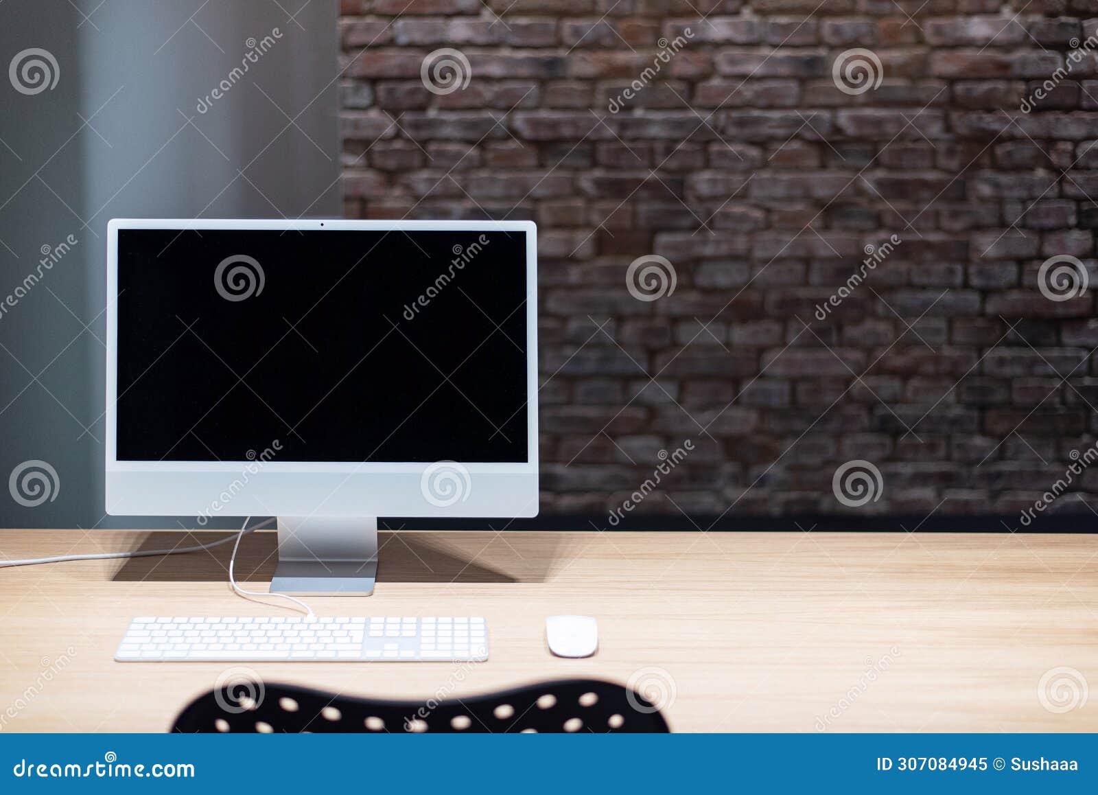 Computer Screen on Wooden Desk, Brick Wall in the Background. Modern ...