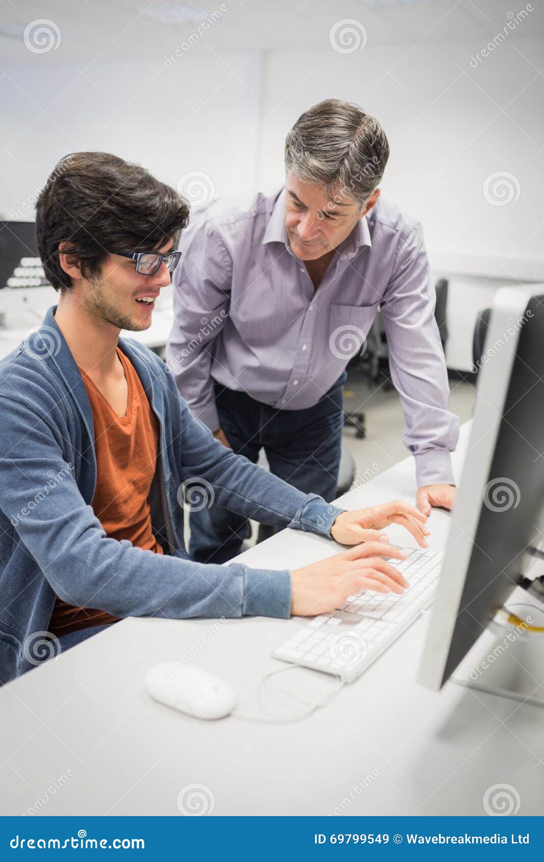 Computer Teacher Assisting a Student Stock Image - Image of adult ...