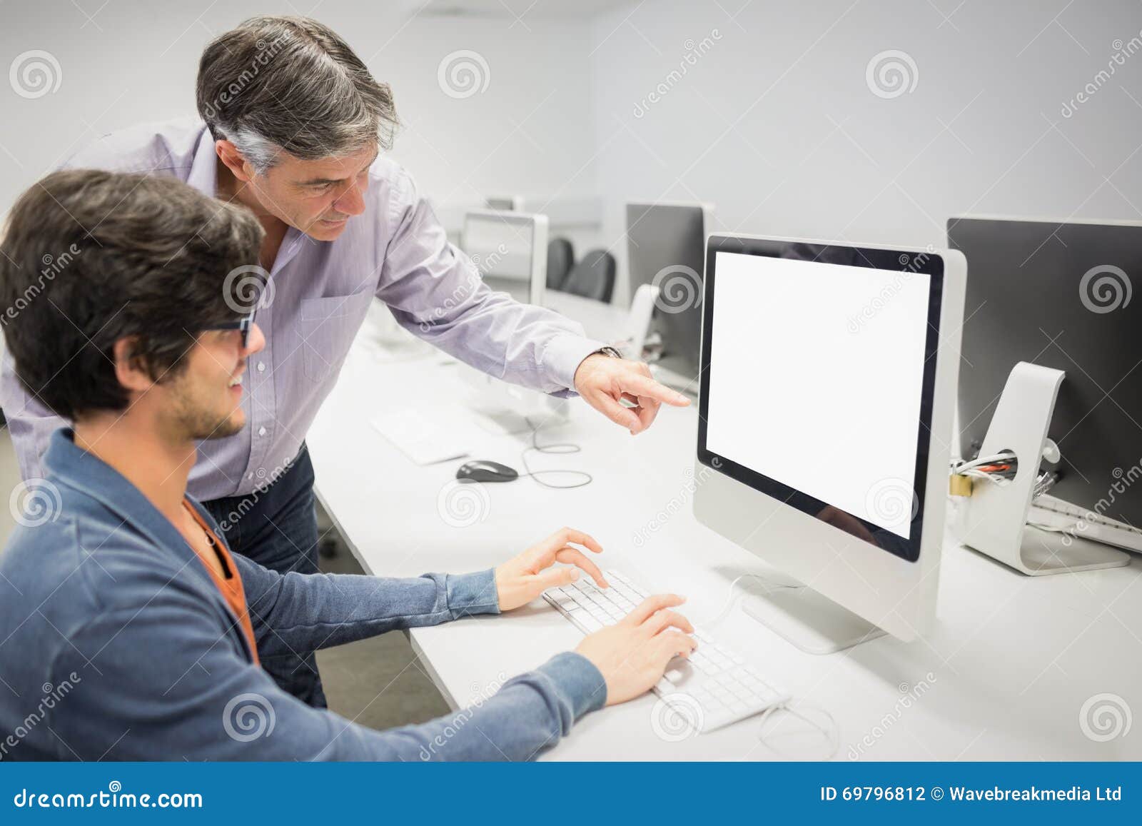 Computer Teacher Assisting a Student Stock Photo - Image of keyboard ...