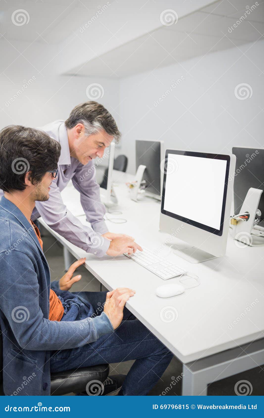 Computer Teacher Assisting a Student Stock Image - Image of ...