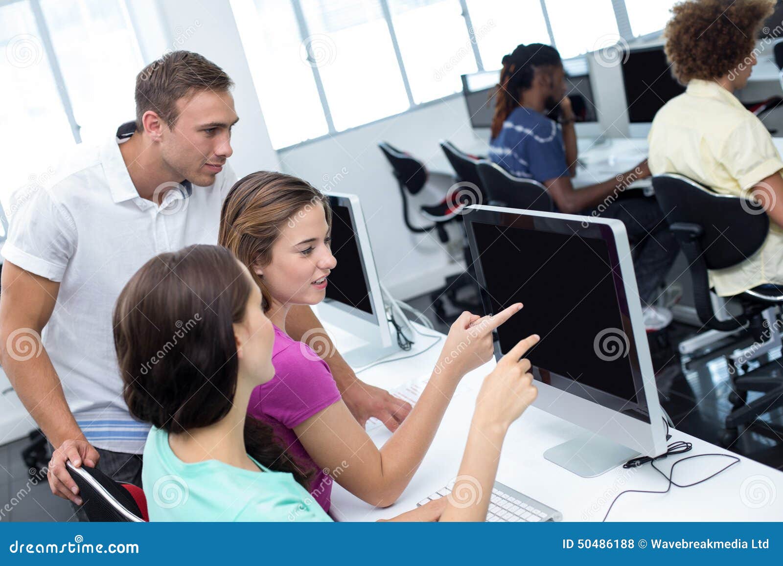 Computer Teacher Helping Pretty Female Students Stock Photo - Image of ...