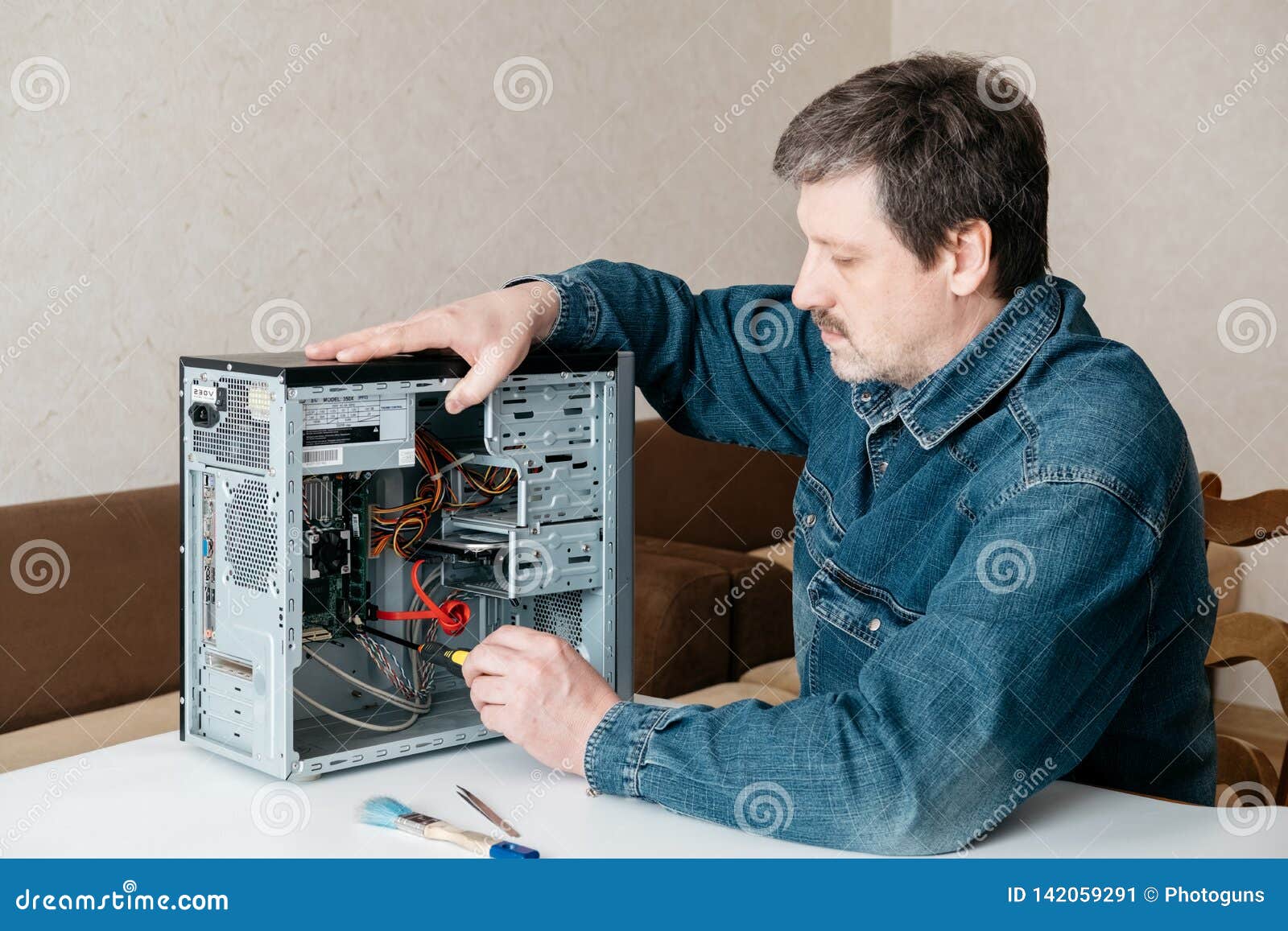 Computer Technician Engineer with Screwdriver in His Hand is Repairing ...