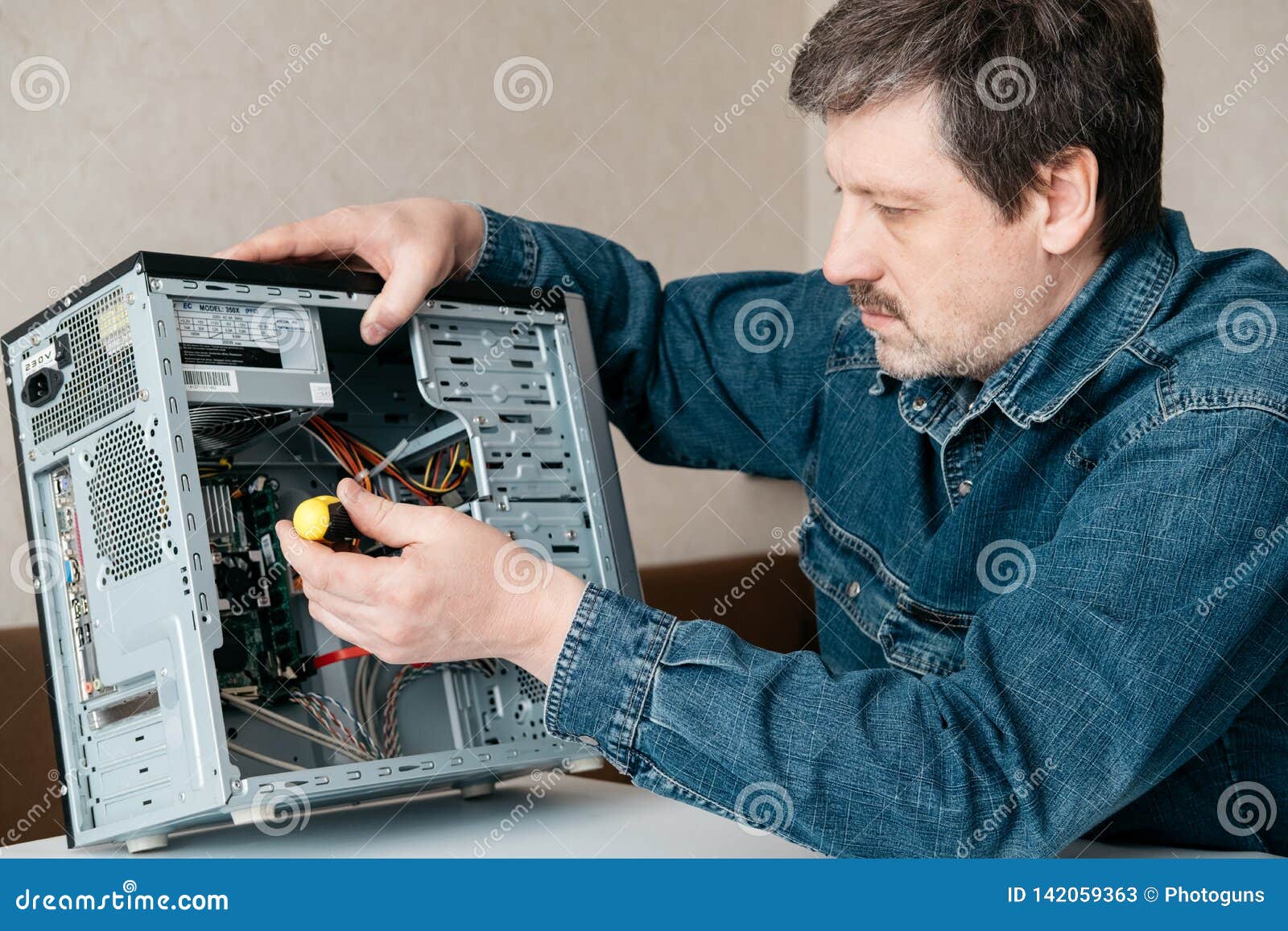 Computer Technician Engineer with Screwdriver in His Hand is Repairing ...