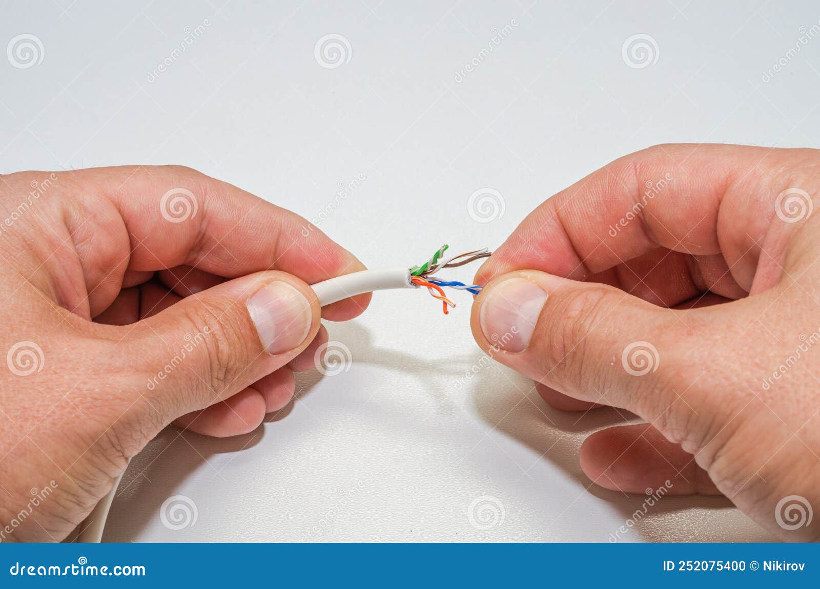 A Computer Wizard Strips the Wires of an Internet Cable for Connecting ...