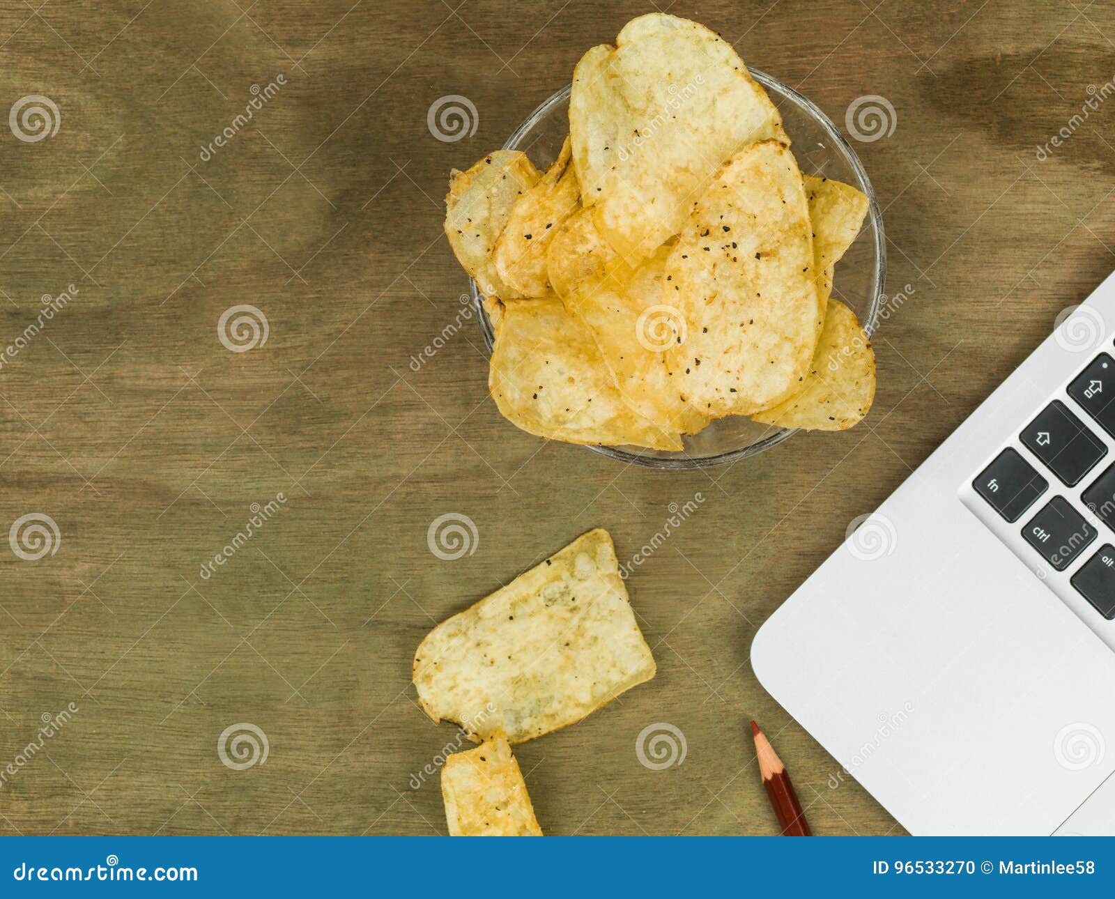 Computer Workstation with a Boewl of Potato Crisps or Potato Chi Stock ...