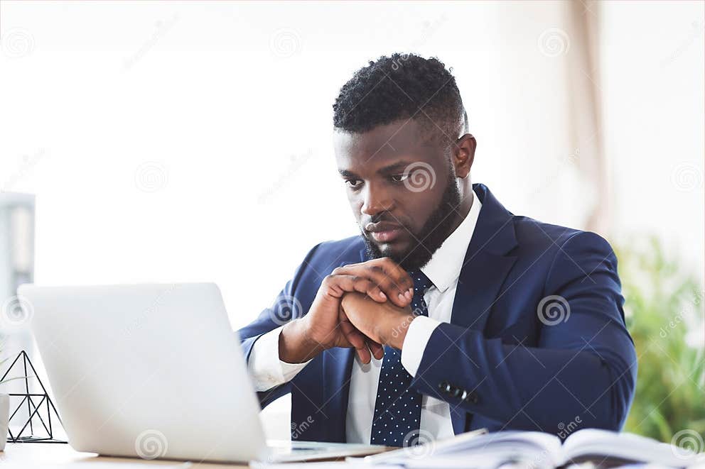Concentrated African American Guy Working with Laptop in Office Stock ... Concentrated African American Guy Working with Laptop in Office Stock ...