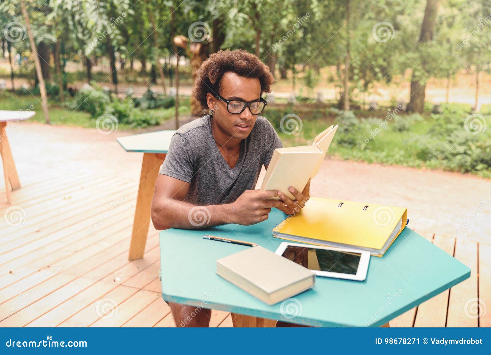 Concentrated African Young Man Sitting and Reading Book Stock Image ...