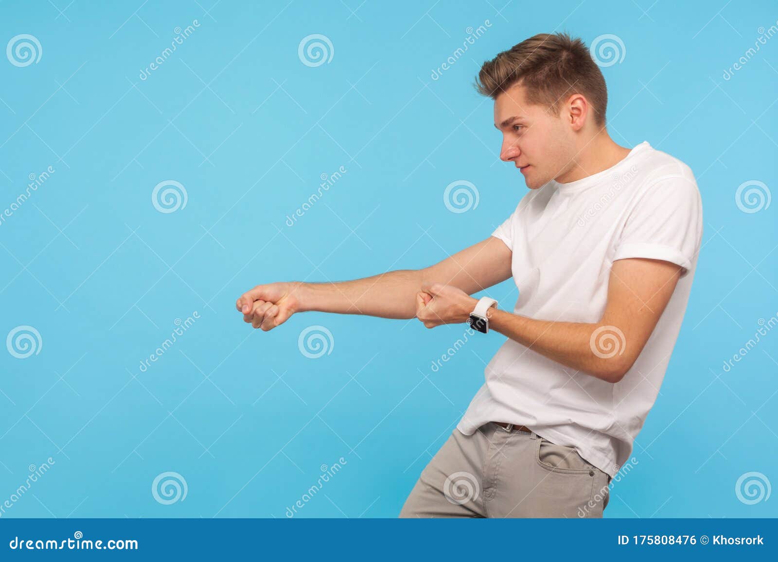 Concentrated Assertive Man Holding Invisible Rope and Pulling Something ...
