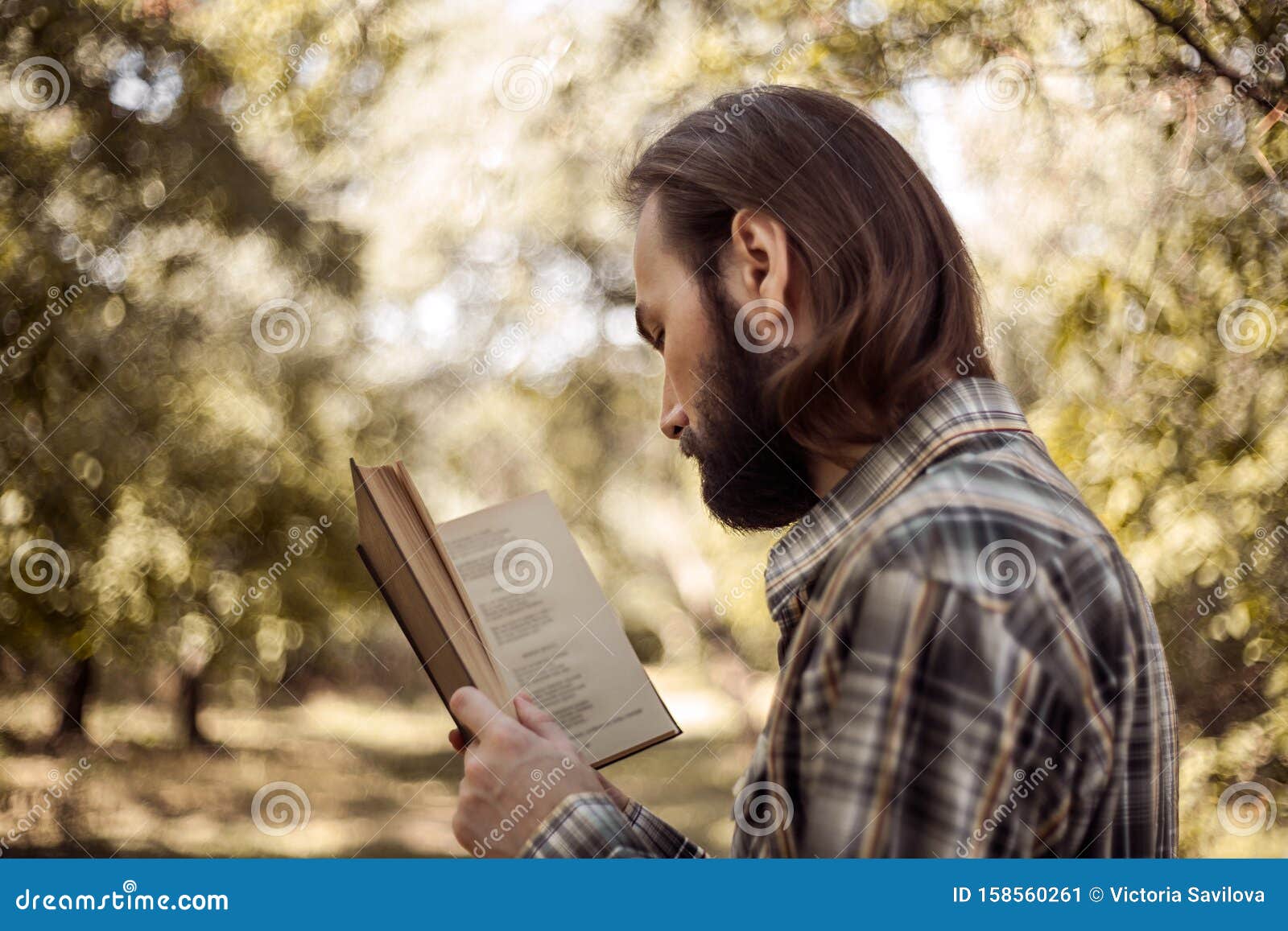 Concentrated Bearded Man Reading A Book In The Park Stock Image Image