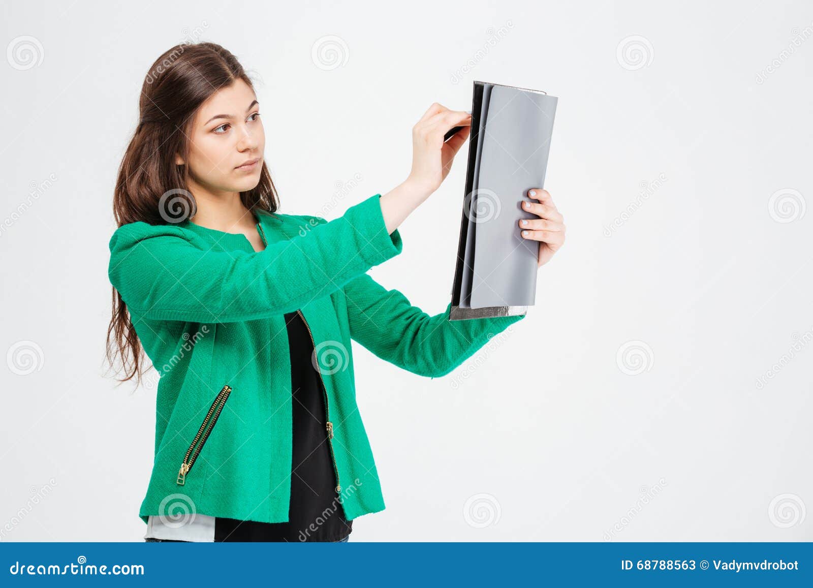 Concentrated Beautiful Woman in Green Jacket Holding Clipboard and ... Concentrated Beautiful Woman in Green Jacket Holding Clipboard and ...