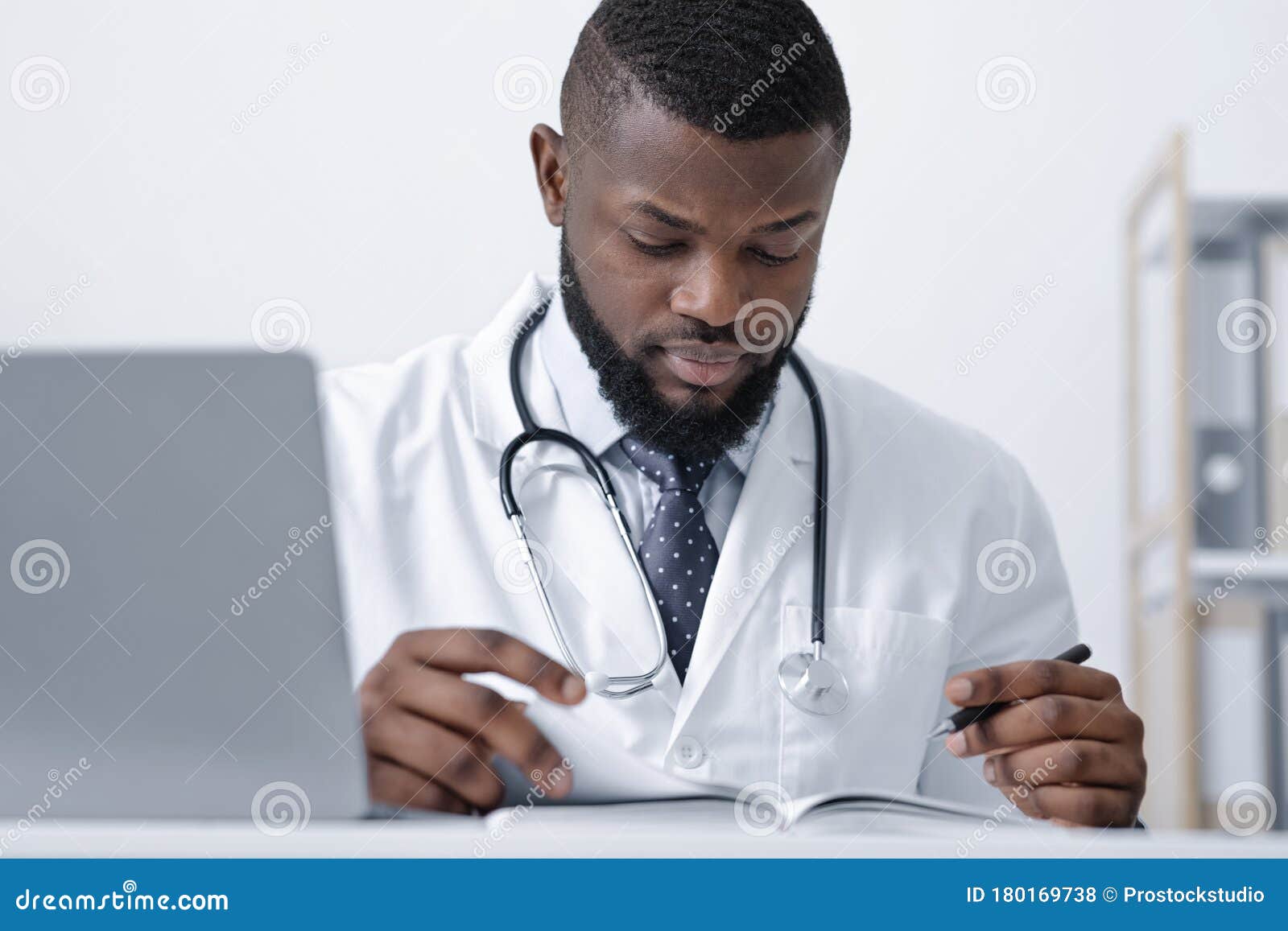 Concentrated Black Doc Planning His Day in Office Stock Photo - Image ...