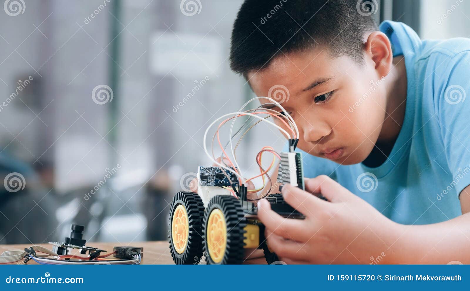 Concentrated Boy Creating Robot at Lab Stock Photo - Image of ...