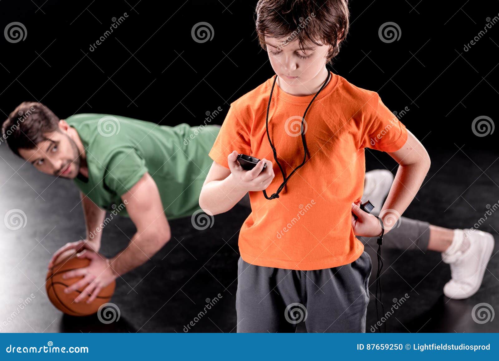 Concentrated Boy with Stopwatch Controlling Time while Man Training ...